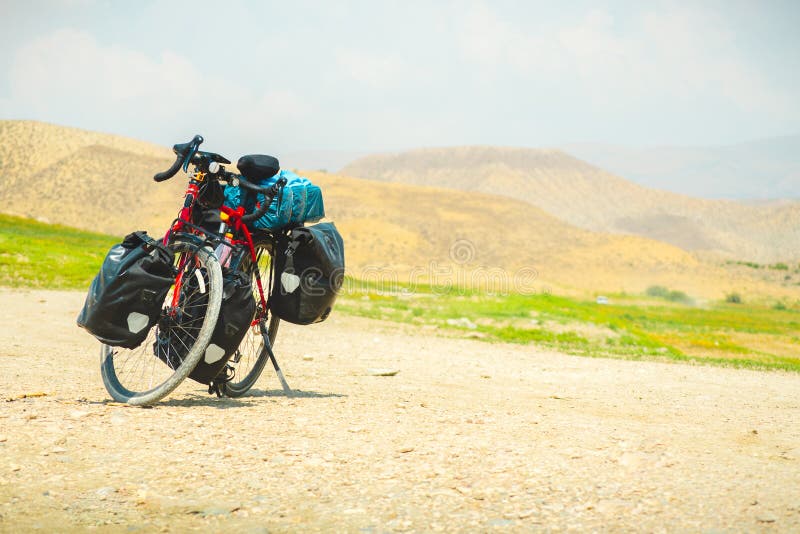 Loaded Touring Bicycle Stands with Moody Dramatic Panoramic Mountains ...