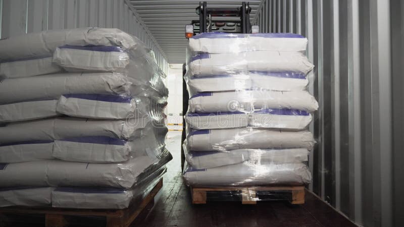 The Loader Driver Loads and Unloads Pallets with Bags in a Very Dark ...