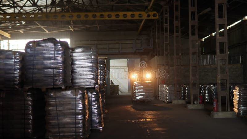 The Loader Driver Loads and Unloads Pallets with Bags in a Very Dark ...
