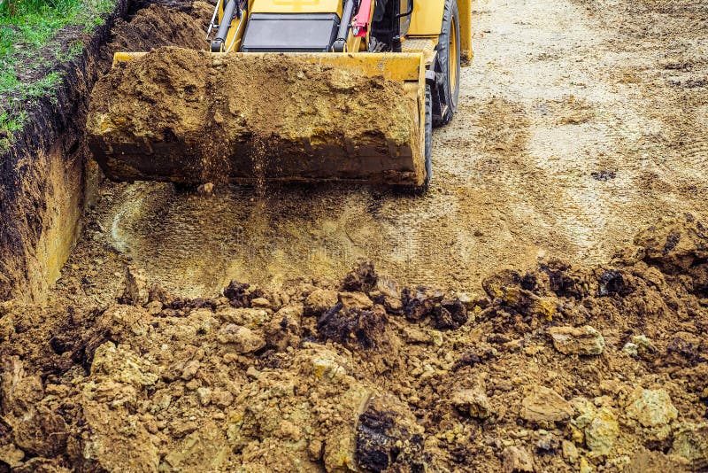 Backhoe Loader Moves Clay Soil in the Excavation To the Dump Stock ...