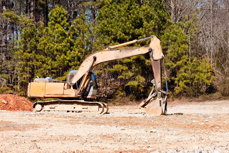 Loader in Field by Pine Trees Stock Photo - Image of site, construction ...