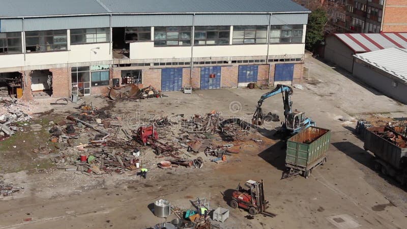 Loader Manipulator with Hydraulic Grappling Claw is Loading Scrap Metal ...