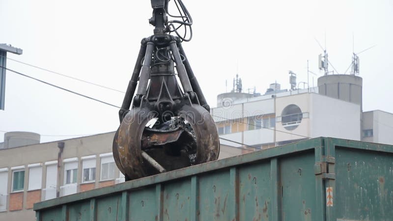 Loader Manipulator with Hydraulic Grappling Claw is Loading Scrap Metal ...
