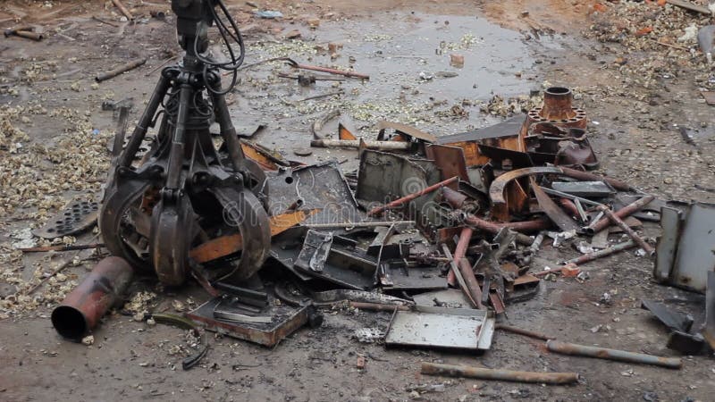 Loader Manipulator with Hydraulic Grappling Claw is Loading Scrap Metal ...