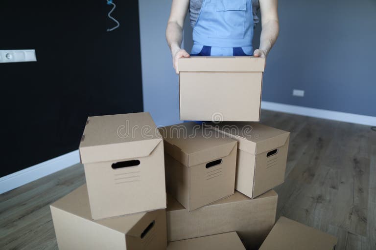 Loader Stacks Cardboard Boxes in an Empty Room Stock Photo - Image of ...