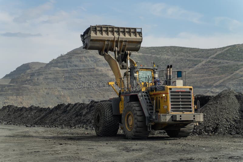The Loader Stands with the Bucket Lifted in the Open Pit. Stock Image ...