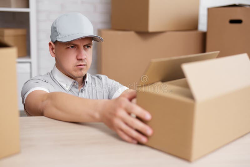 Loader Taking a Box from Shelf in Warehouse Stock Image - Image of ...