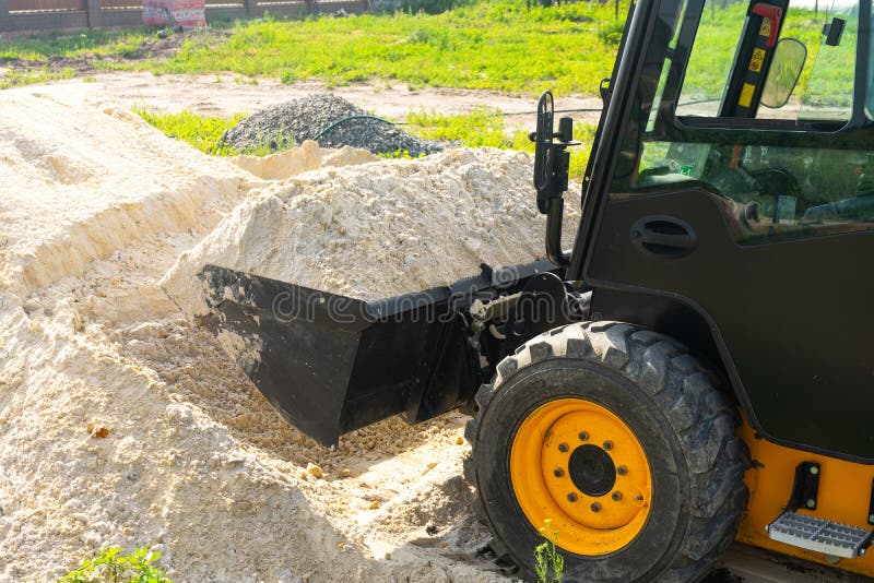 The Loader Took the Sand into the Bucket for Construction Work. Stock ...