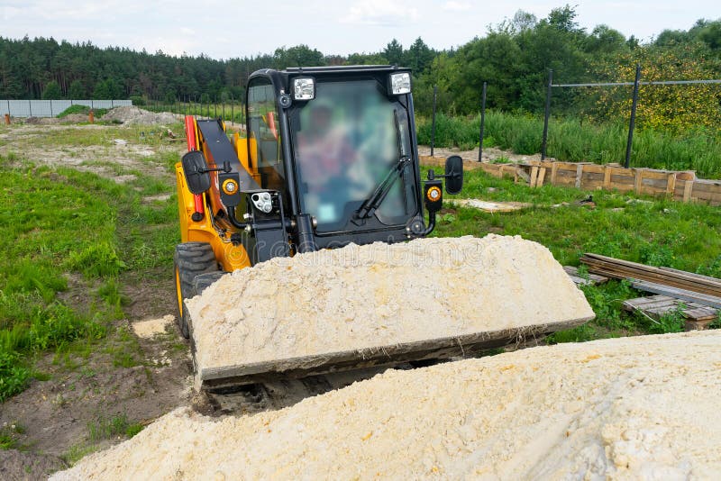 The Loader Took the Sand into the Bucket for Construction Work Stock ...