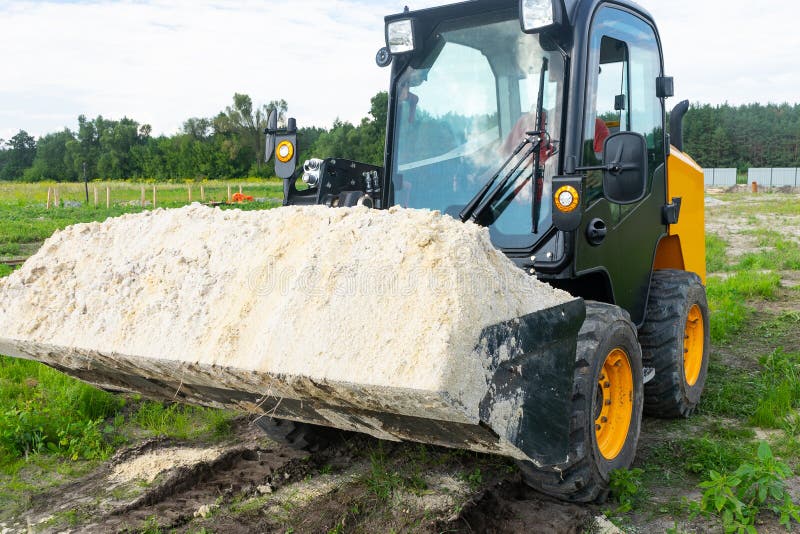 The Loader Took the Sand into the Bucket for Construction Work Stock ...