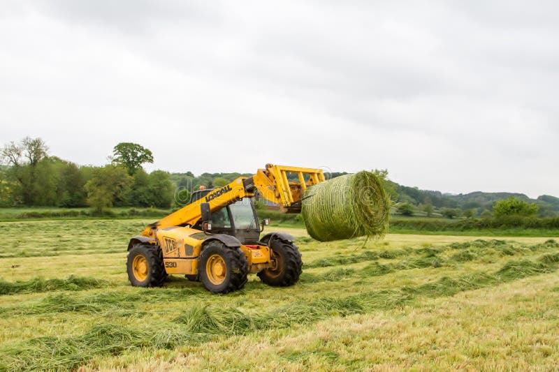 Loader Tractor Moving a Round Bale from Field Editorial Stock Photo ...