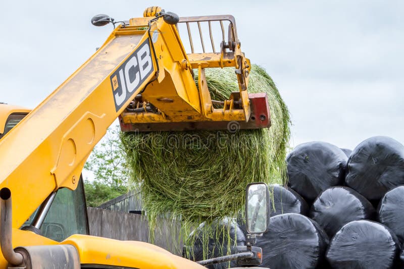 Loader Tractor Stacking Round Bales in a Stack Editorial Photography ...
