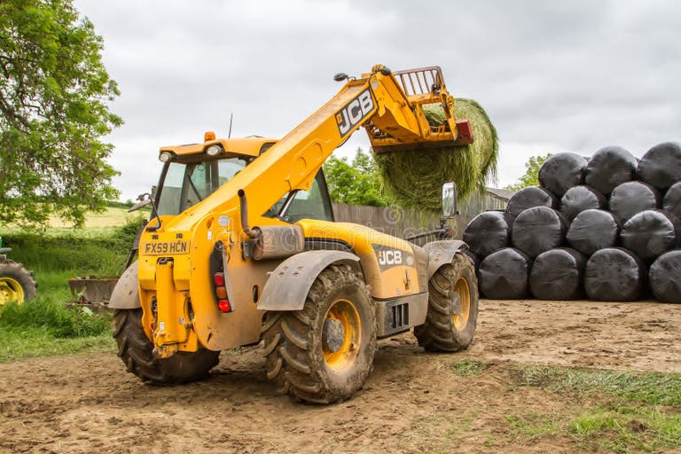 Loader Tractor Stacking Round Bales in a Stack Editorial Photo - Image ...