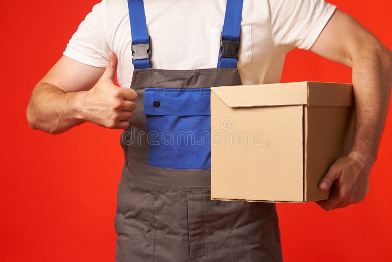 Loader in Work Clothes Brought a Parcel in a Cardboard Box. Stock Photo ...