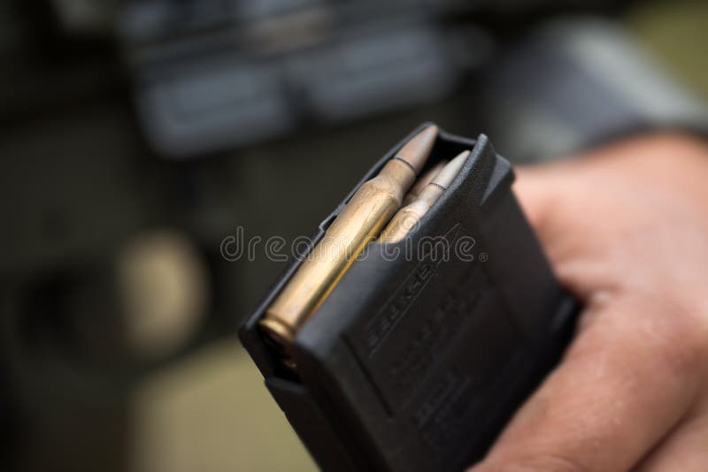 Loading Ammunition into a Clip. Reloading Weapons. Stock Image - Image ...