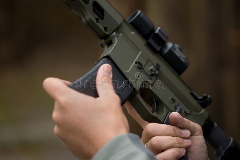 Loading Ammunition into a Clip. Reloading Weapons. Stock Photo - Image ...