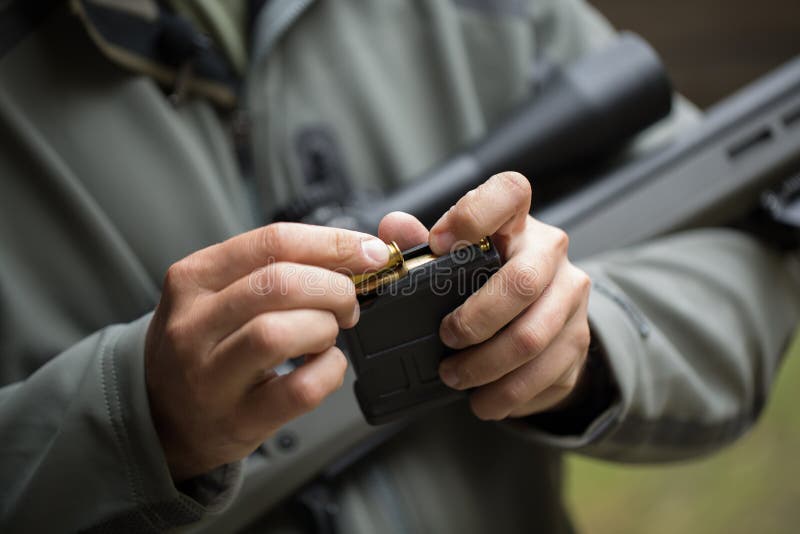 Loading Ammunition into a Clip. Reloading Weapons. Stock Photo - Image ...