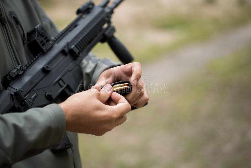Loading Ammunition into a Clip. Reloading Weapons. Stock Image - Image ...