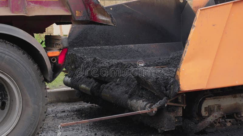 Loading Asphalt into the Paving Machine Road Construction. Slow Motion ...