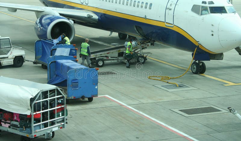 Loading luggage onto plane stock image. Image of traveling - 2435797