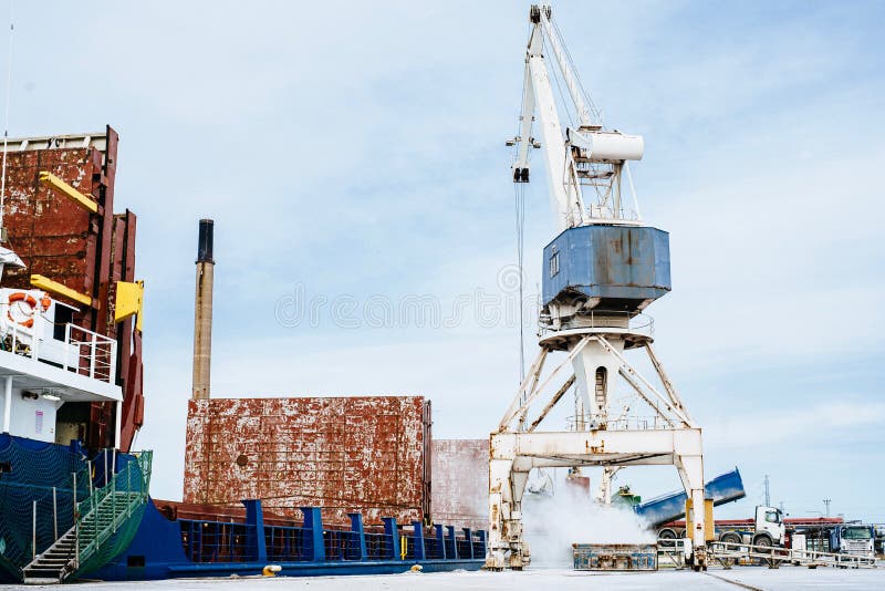 Loading Bulk Cargo on the Cargo Ship. Old Crane. Bulk Cargo Termonal ...