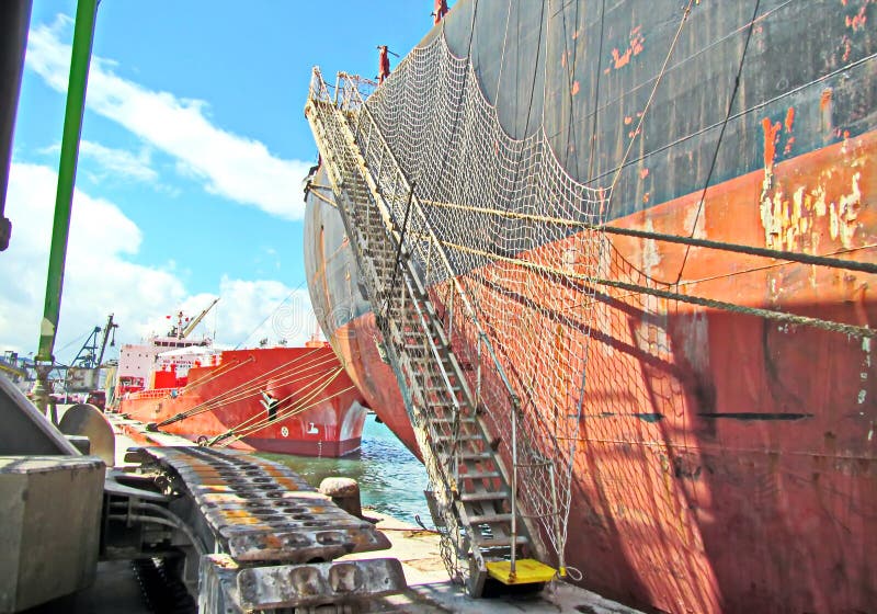 Loading Cargo of Cement Clinker in Bulk Carrier by Ships Cranes in the ...