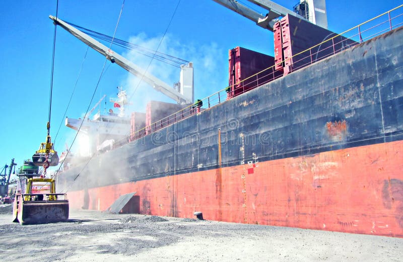 Loading Cargo of Cement Clinker in Bulk Carrier by Ships Cranes in the ...