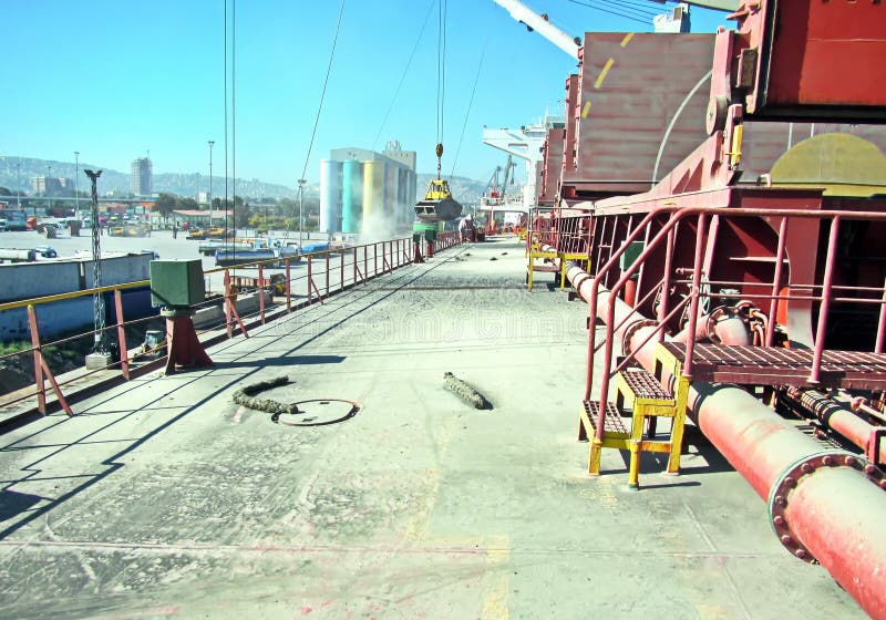 Loading Cargo of Cement Clinker in Bulk Carrier by Ships Cranes in the ...