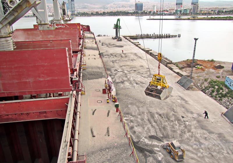 Loading Cargo of Cement Clinker in Bulk Carrier by Ships Cranes in the ...