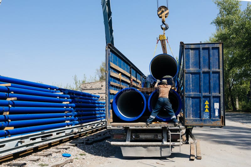 Loading Cast Iron Pipe into Truck for Transportation by Overhead Crane ...