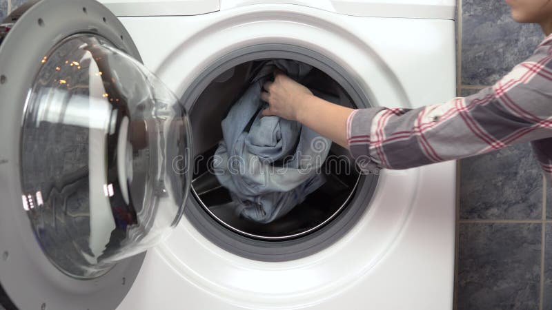 Loading Clothes into the Washing Machine Stock Photo - Image of ...