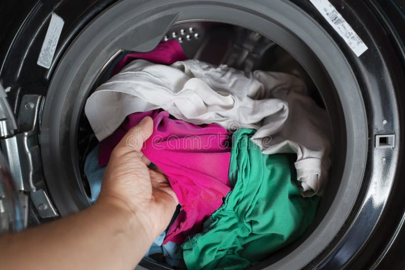 Loading Clothes into the Washing Machine Stock Photo - Image of laundry ...