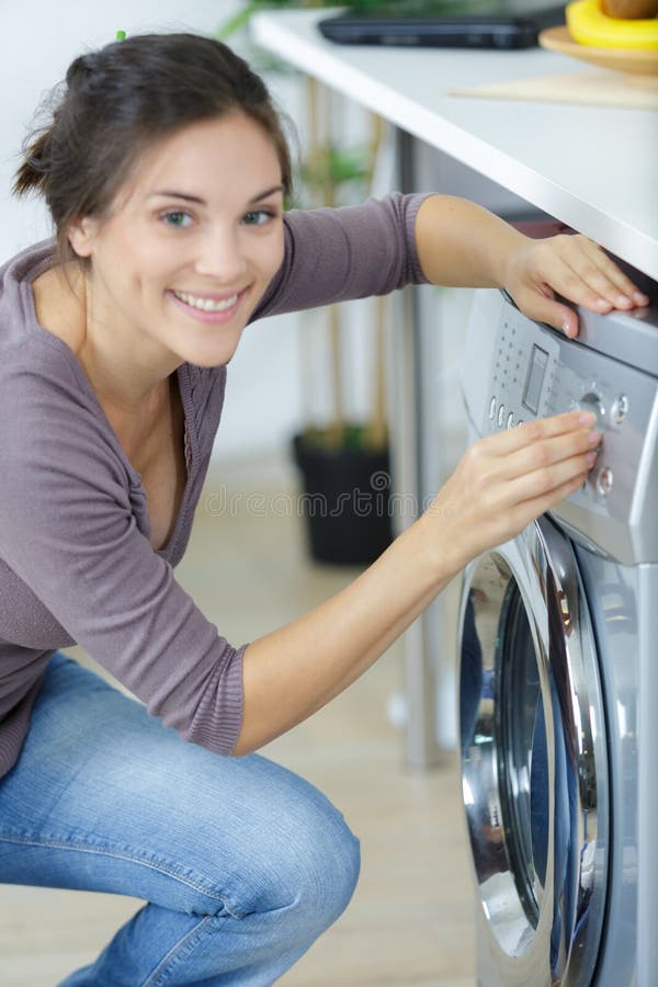 Loading Clothes into Washing Machine Stock Image - Image of kitchen ...