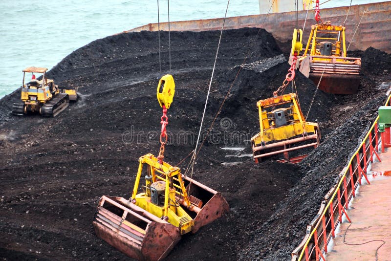 Loading Coal from Cargo Barges Onto a Bulk Carrier Using Ship Cranes ...