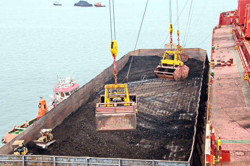 Loading Coal from Cargo Barges Onto a Bulk Carrier Using Ship Cranes ...