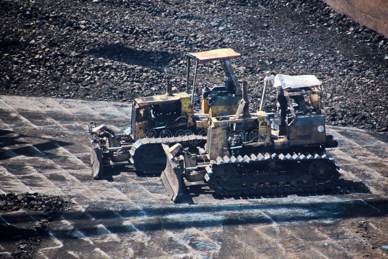 Loading Coal from Cargo Barges Onto a Bulk Carrier Using Ship Cranes ...