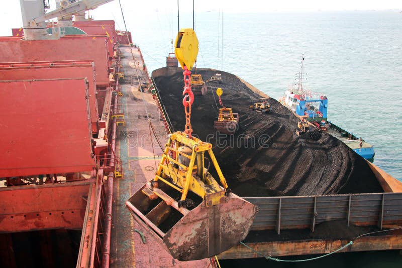 Loading Coal from Cargo Barges Onto a Bulk Carrier Using Ship Cranes ...