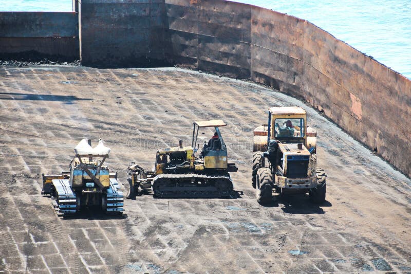 Loading Coal from Cargo Barges Onto a Bulk Carrier Using Ship Cranes ...