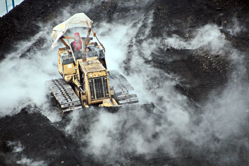 Loading Coal from Cargo Barges Onto a Bulk Carrier Using Ship Cranes ...