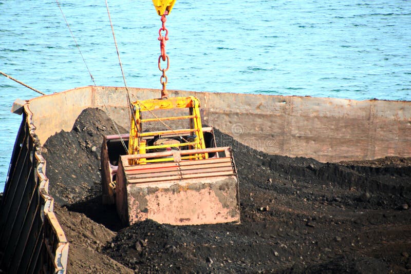 Loading Coal from Cargo Barges Onto a Bulk Carrier Using Ship Cranes ...
