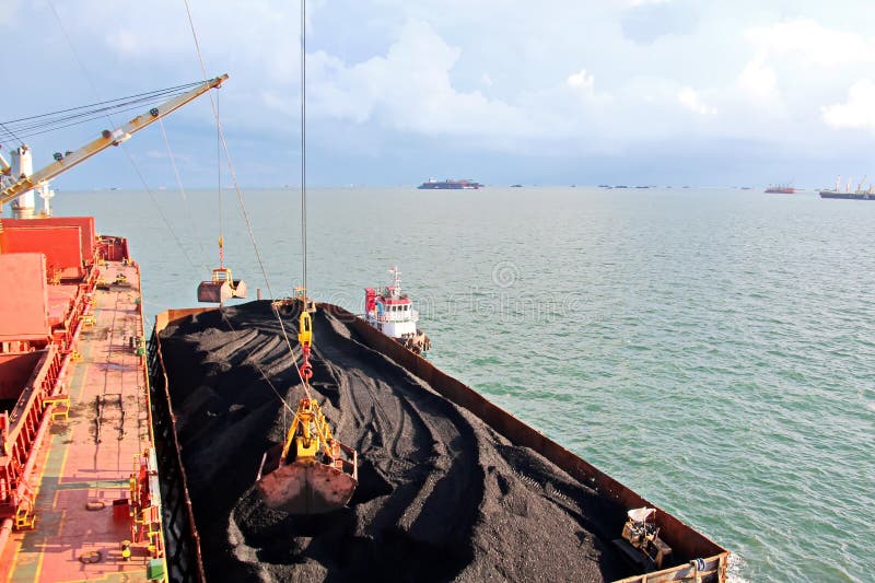 Loading Coal from Cargo Barges Onto a Bulk Carrier Using Ship Cranes ...