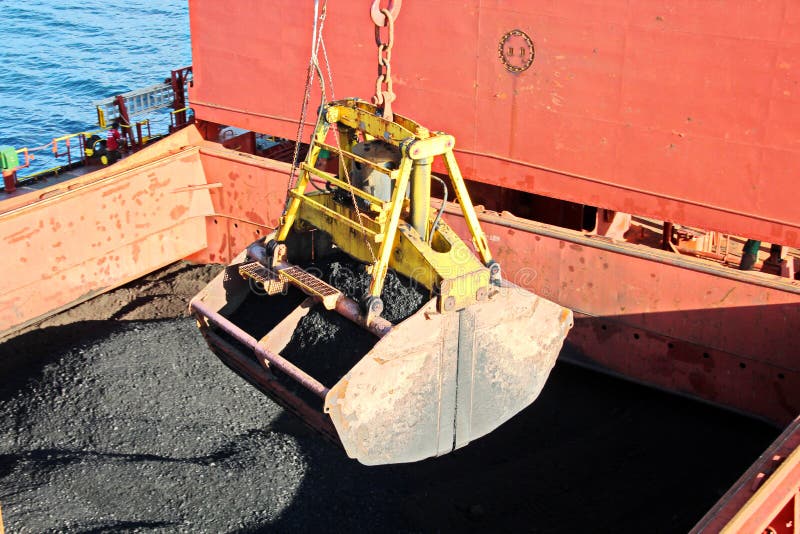 Loading Coal from Cargo Barges Onto a Bulk Carrier Using Ship Cranes ...