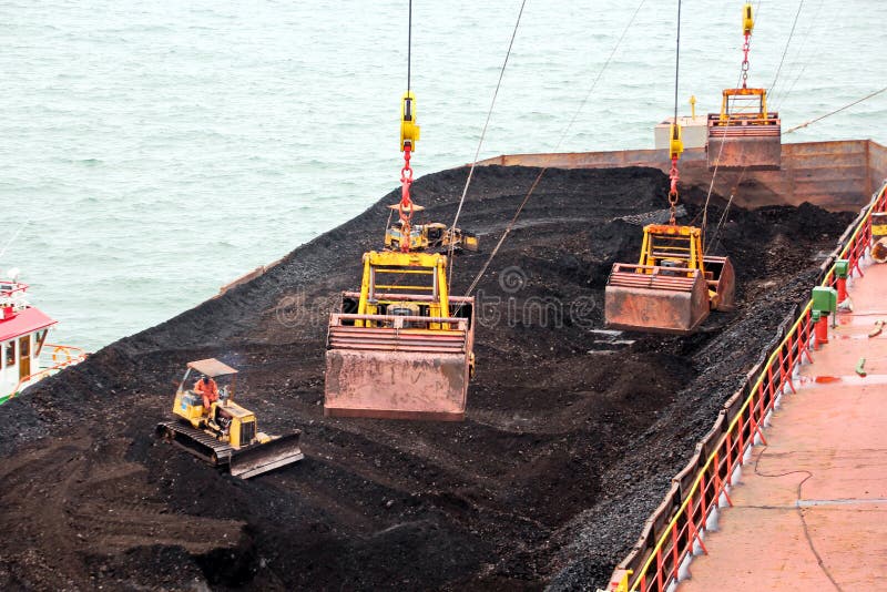 Loading Coal from Cargo Barges Onto a Bulk Carrier Using Ship Cranes ...