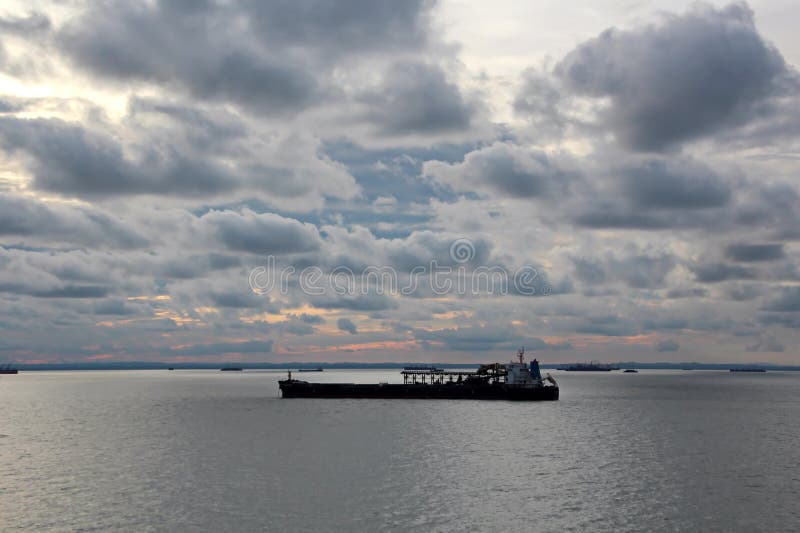 Loading Coal from Cargo Barges Onto a Bulk Carrier Using Ship Cranes ...