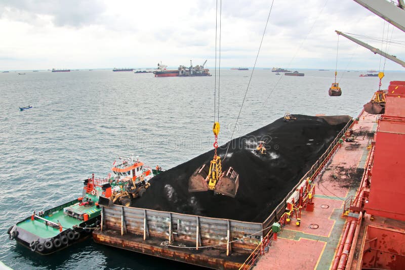Loading Coal from Cargo Barges Onto a Bulk Carrier Using Ship Cranes ...