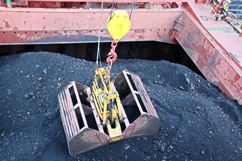 Loading Coal from Cargo Barges Onto a Bulk Carrier Using Ship Cranes ...