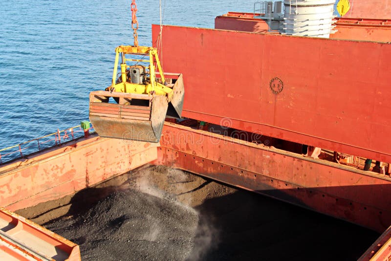 Loading Coal from Cargo Barges Onto a Bulk Carrier Using Ship Cranes ...