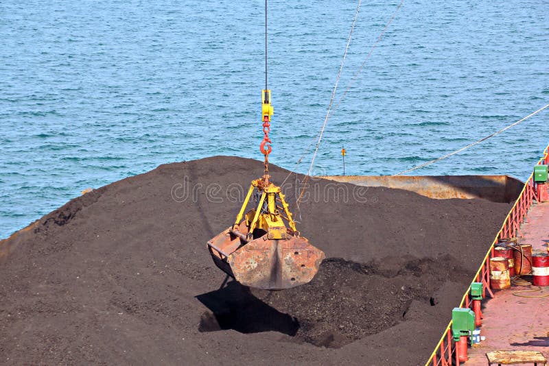 Loading Coal from Cargo Barges Onto a Bulk Carrier Using Ship Cranes ...