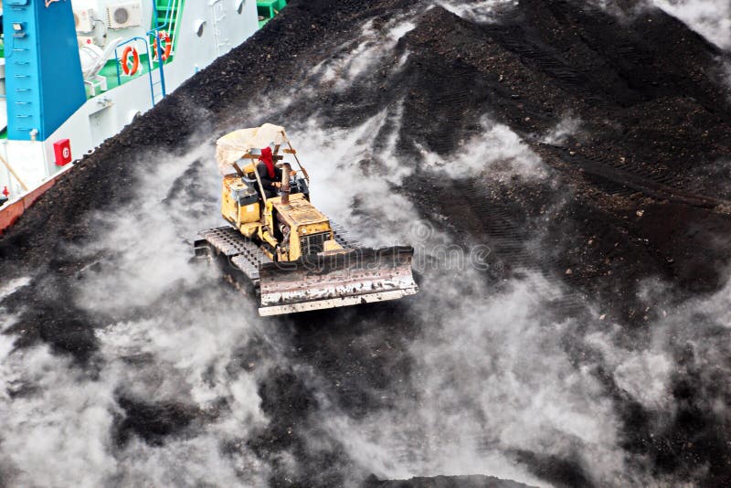 Loading Coal from Cargo Barges Onto a Bulk Carrier Using Ship Cranes ...