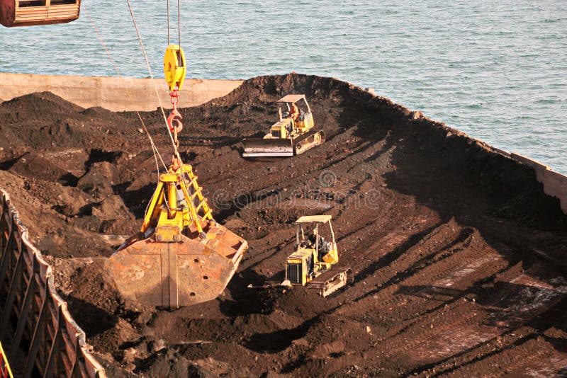 Loading Coal from Cargo Barges Onto a Bulk Carrier Using Ship Cranes ...